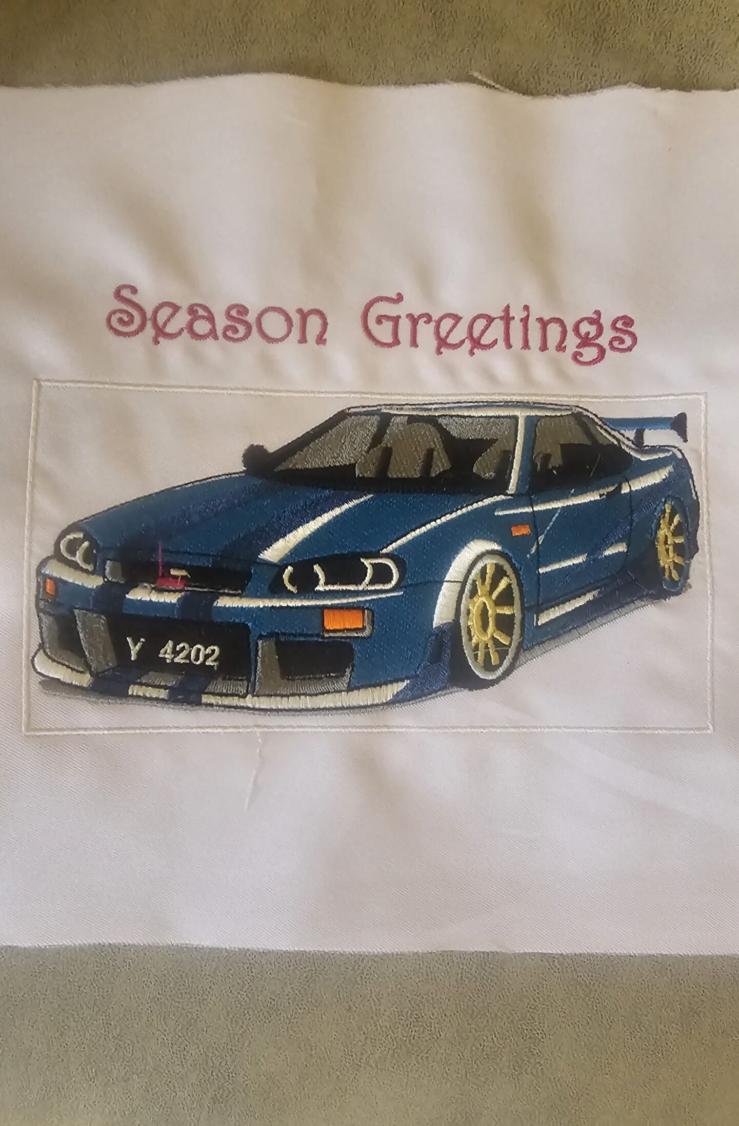 Season’s Greetings – Blue Sports Car Embroidery Design – Mal n Oki